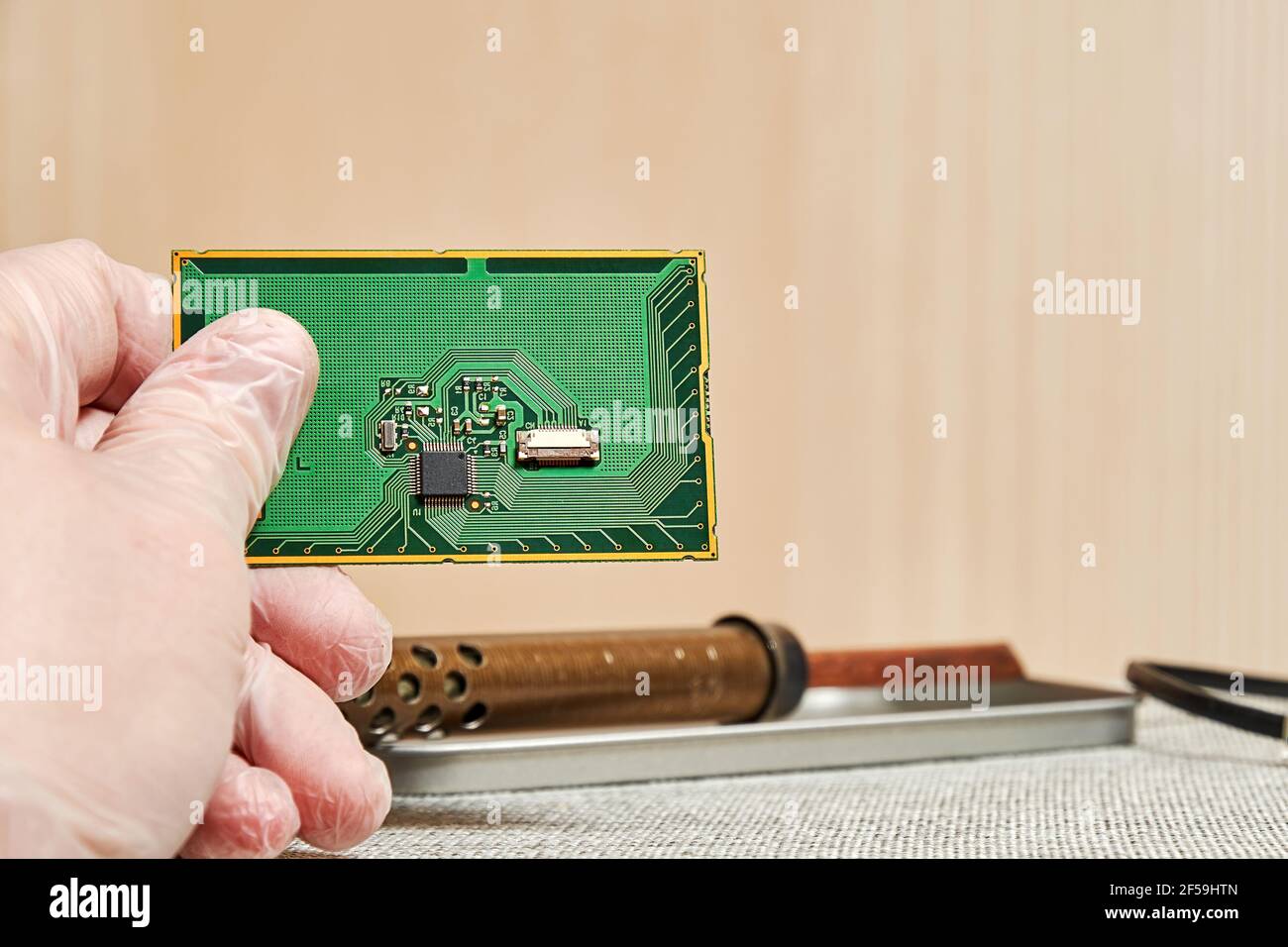 Engineer analyzing PCB with a chip in the hand over the laboratory ...