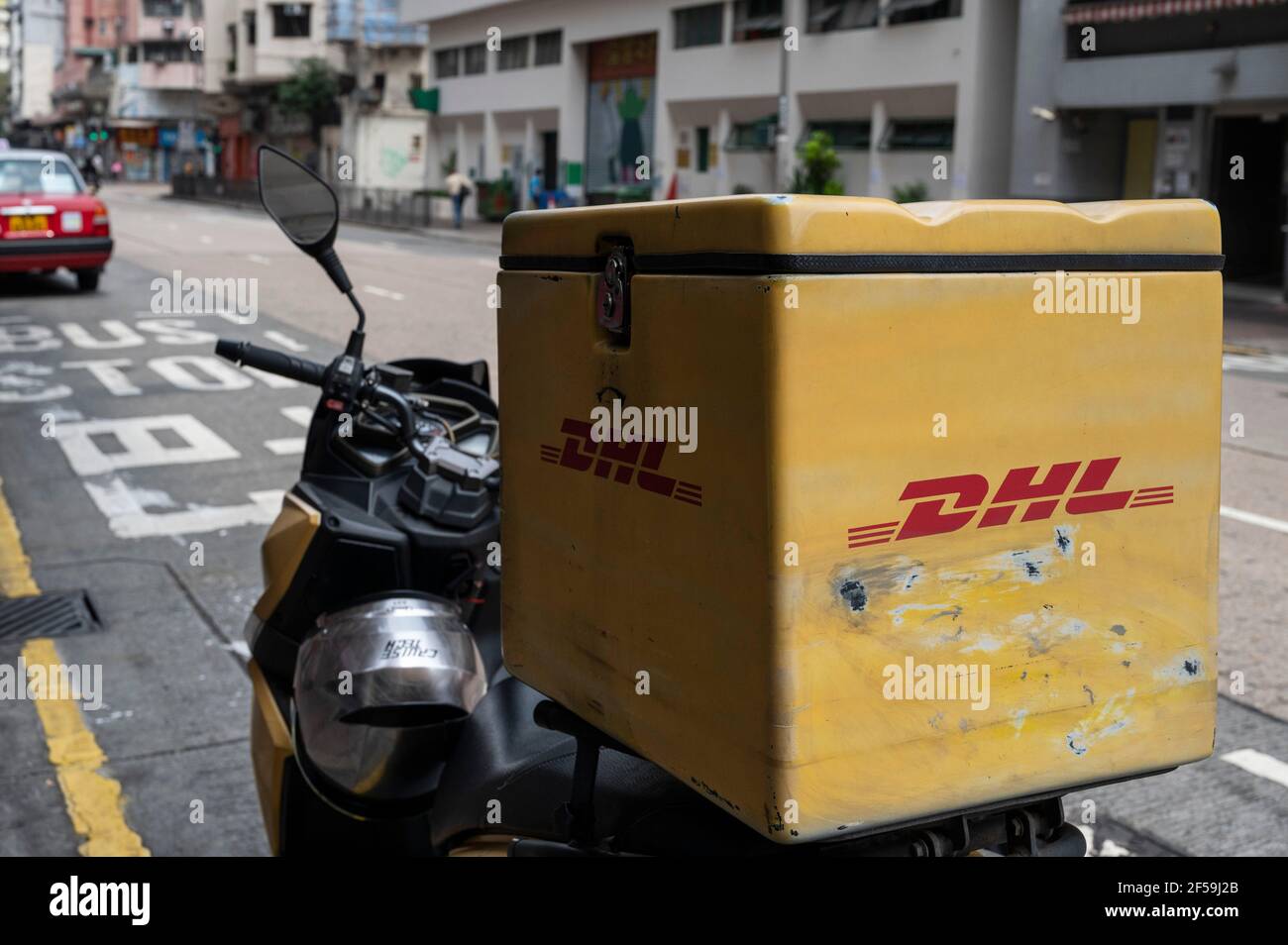 German express delivery mail company DHL motorcycle seen parked on the ...
