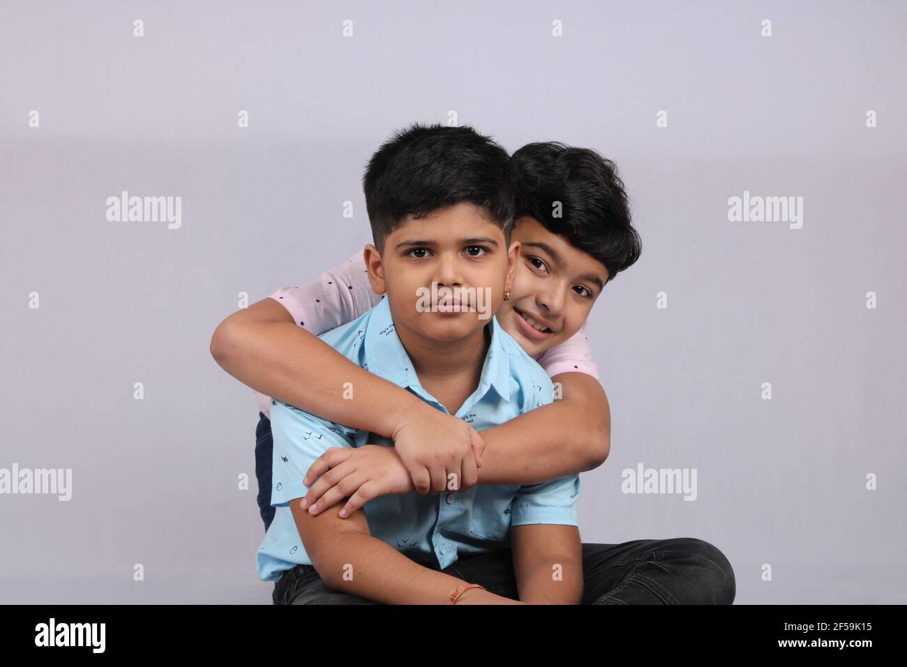cheerful indian siblings hugging and posing for a photo Stock Photo - Alamy