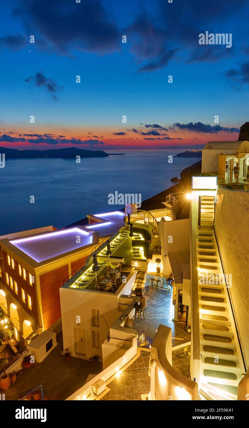 Santorini island at night, Greece. View of Fira town at dusk with ...