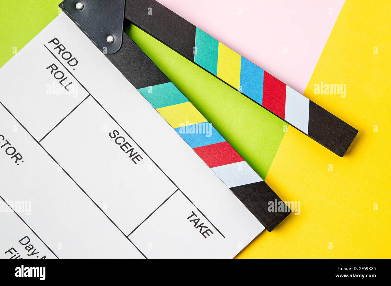 Filmmaker profession. Clapperboard on colorful background Stock Photo ...