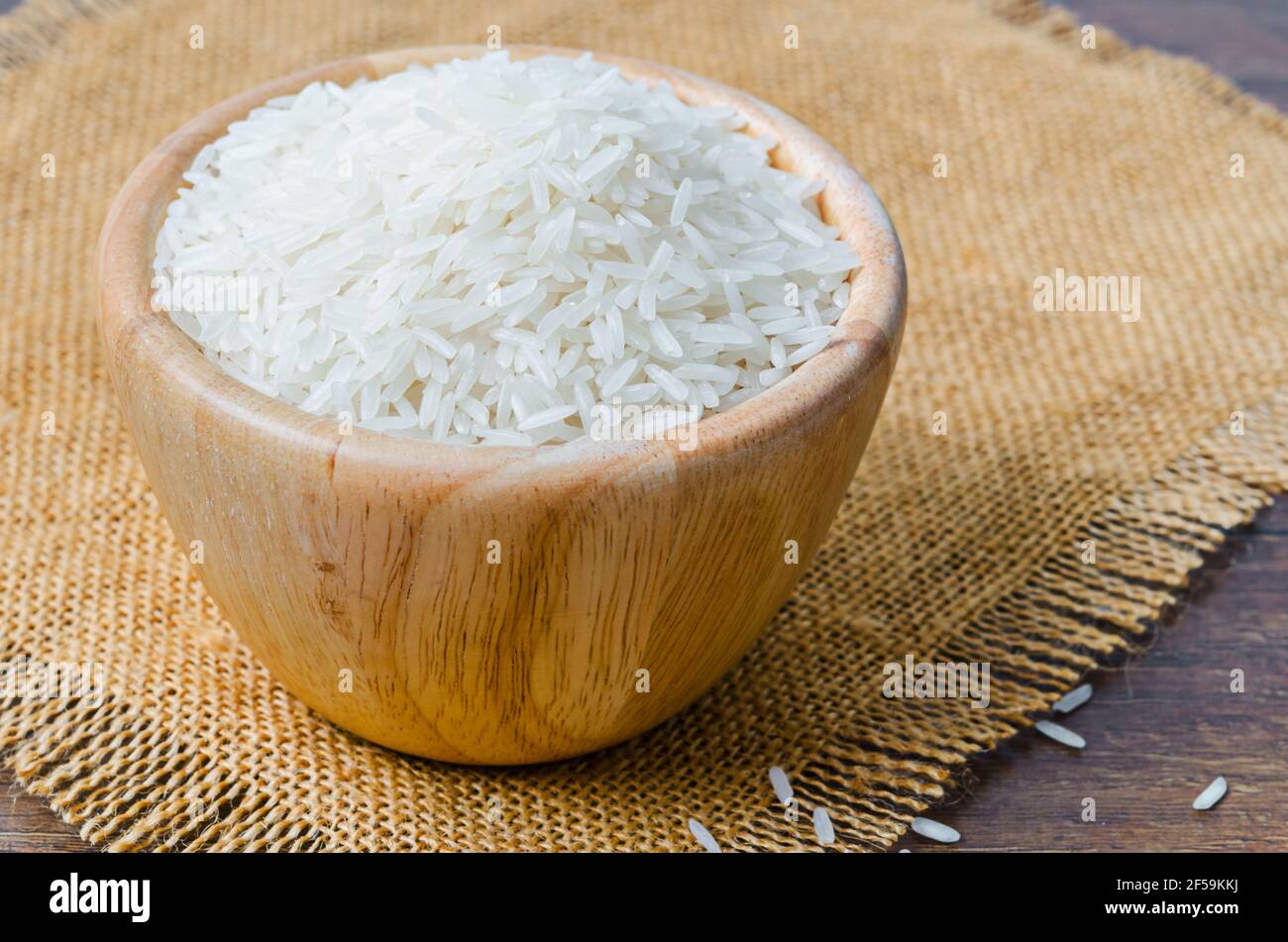 Organic Thai Jasmine rice grain in wooden bowl preparing for cooked ...