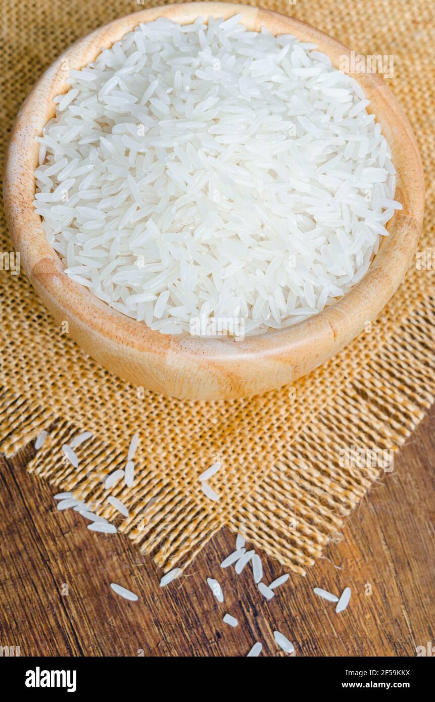 Organic Thai Jasmine rice grain in wooden bowl preparing for cooked ...
