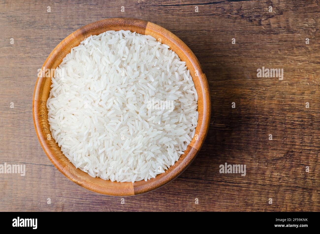 Organic Thai Jasmine rice grain in wooden bowl preparing for cooked ...