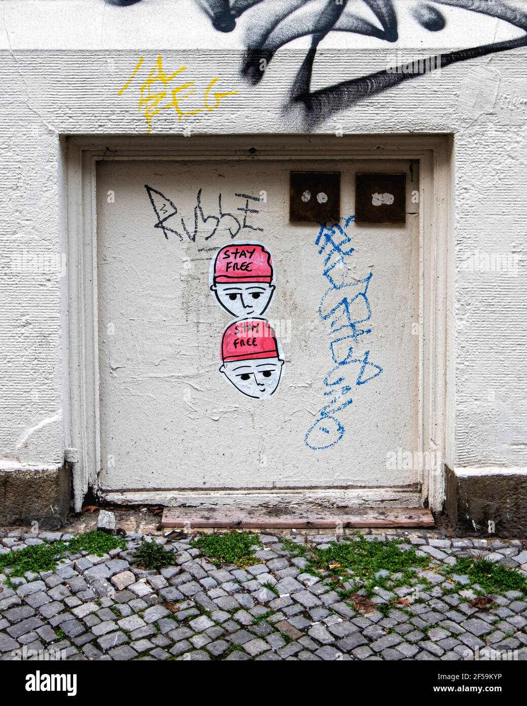 Building detail, basement window, graffiti, urban art, cobbled pavement ...