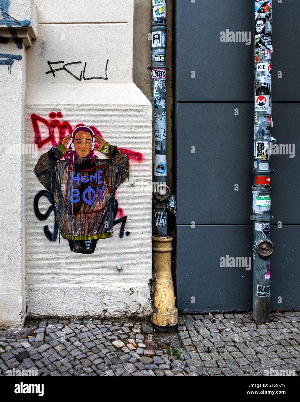 Building detail, sticker covered drain pipes graffiti, urban art ...