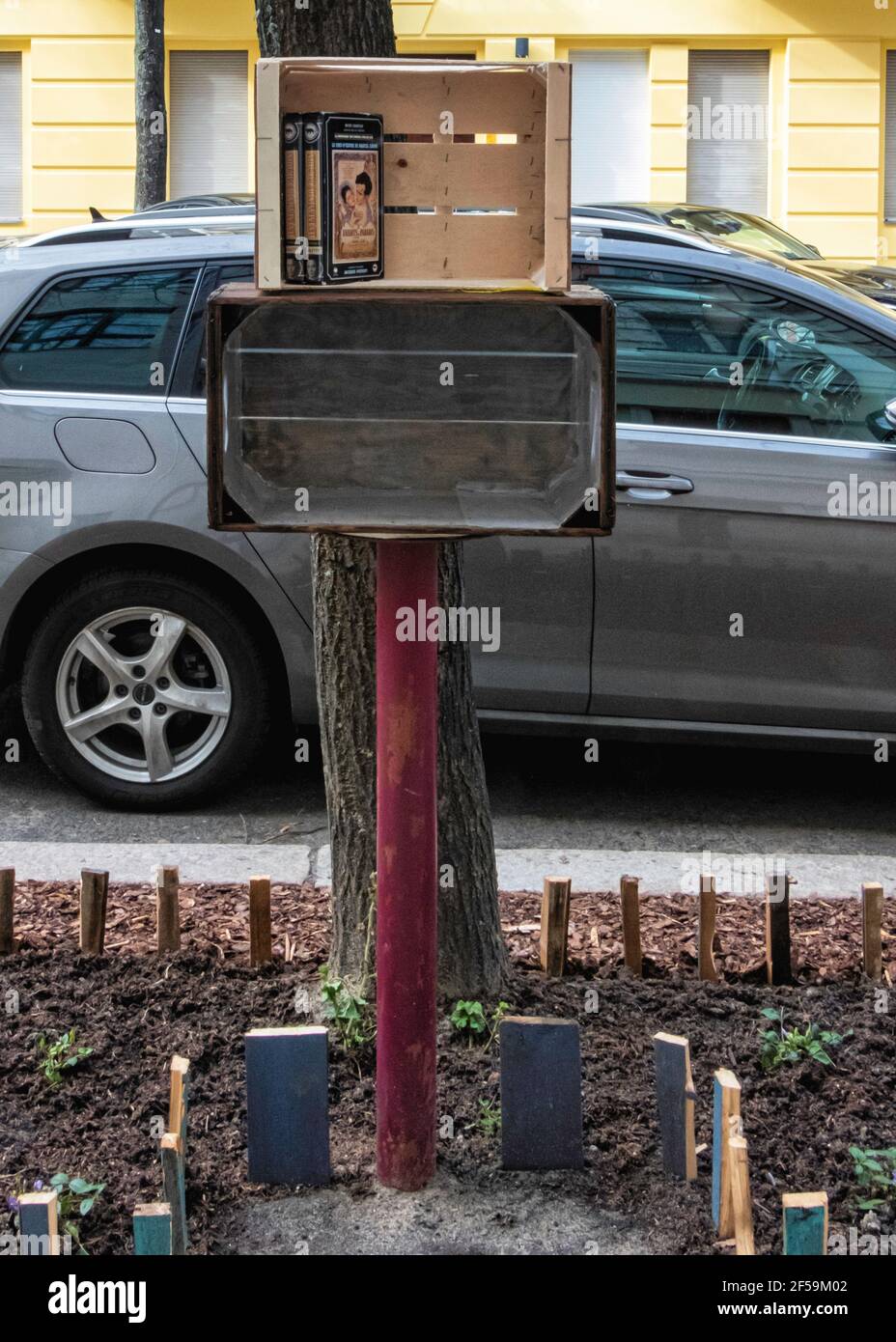 Tiny library for donated books. Two boxes attached to pole on urban ... Tiny library for donated books. Two boxes attached to pole on urban ...