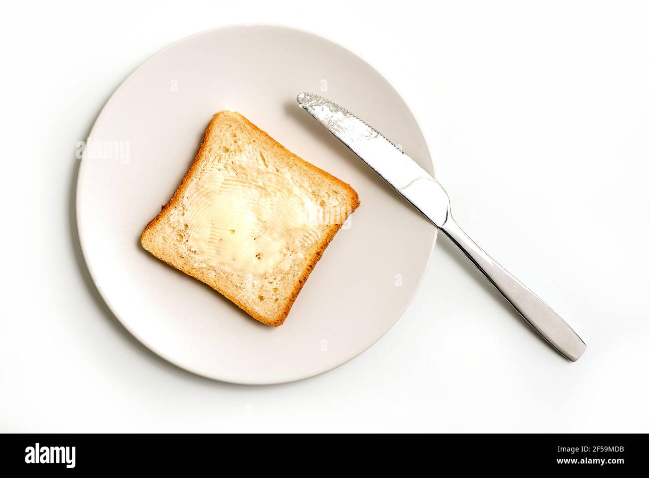 Bread and Butter. Toast with butter in a white plate isolated on white ...