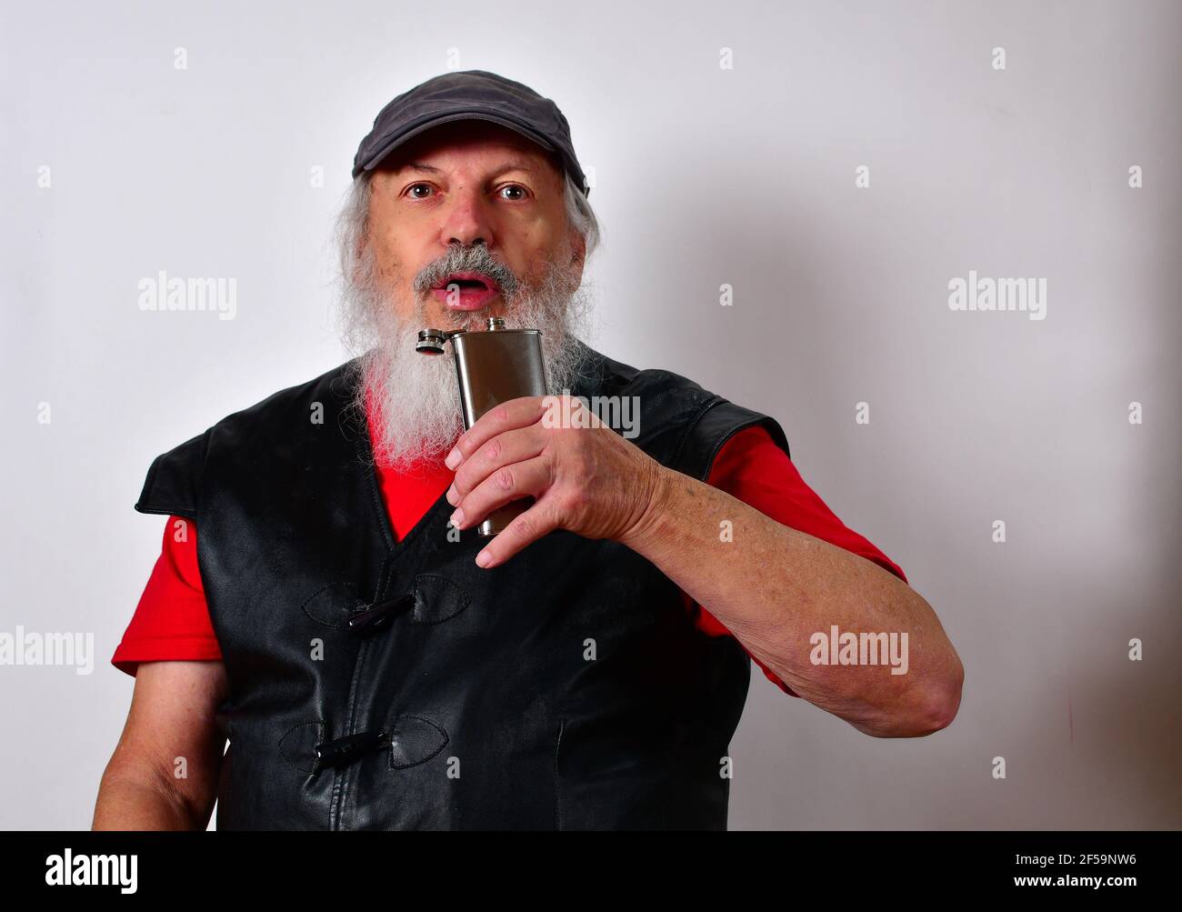 Elderly Caucasian male drinking alcohol from his flask Stock Photo - Alamy
