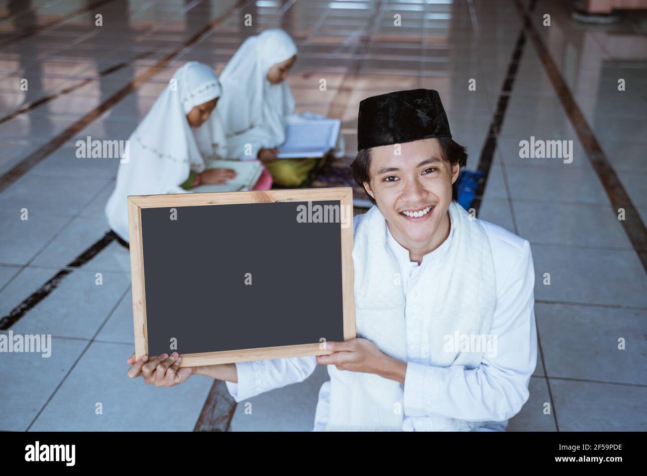 Asian Muslim male teachers hold blank blackboards and Muslim children ...