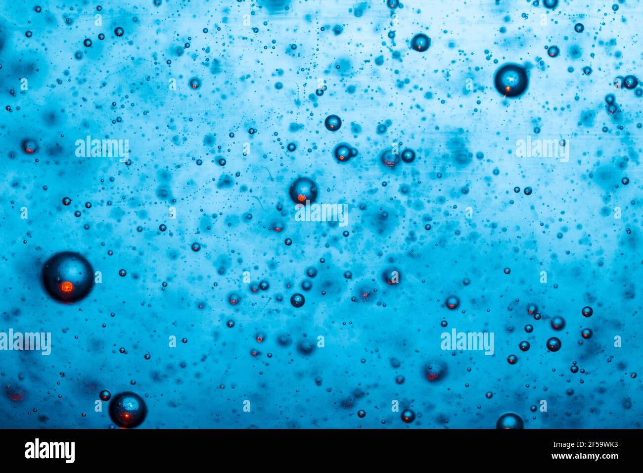 Large beautiful Oxygen bubbles underwater on a blue background macro ...
