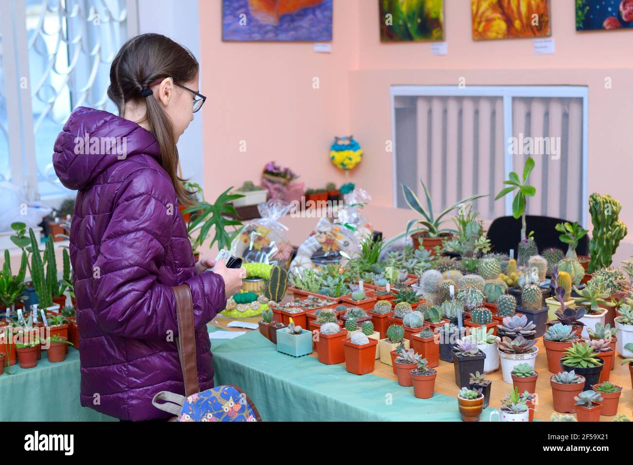 Young girl teeneger buying potted cactus at the flower shop. Kiev ...
