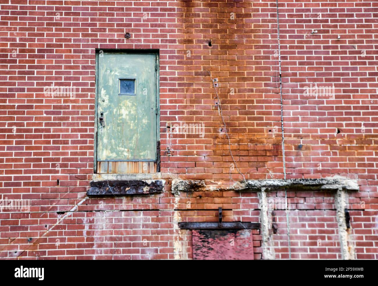 Broken and abandoned brick warehouse building windows and door Stock ...