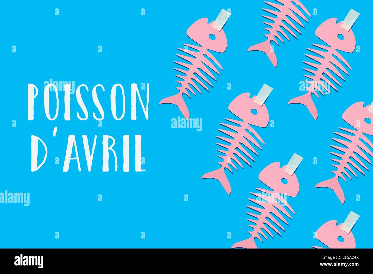 some homemade pink paper fishes and text fish of april written in ...