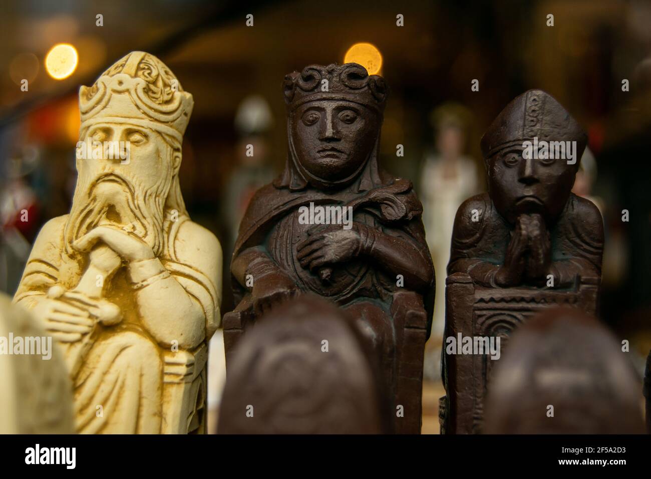 Carved wooden chess pieces closeup, small figures of king, queen and ...