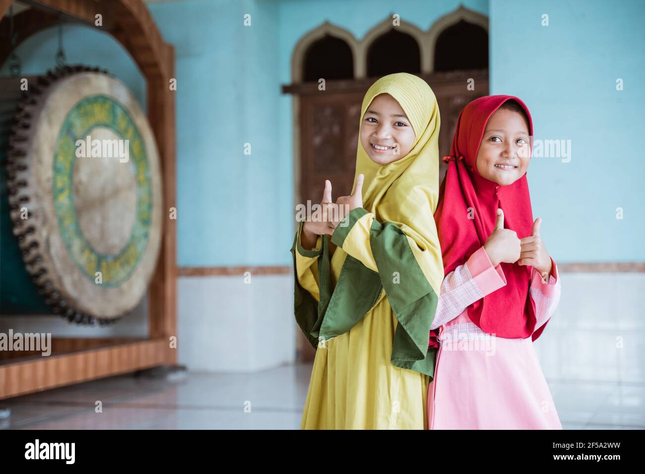 Kids woman Muslim pose and show thumbs looking at cameras Stock Photo ...