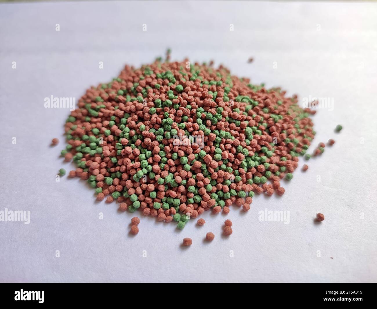Pile of fish food grains Stock Photo - Alamy