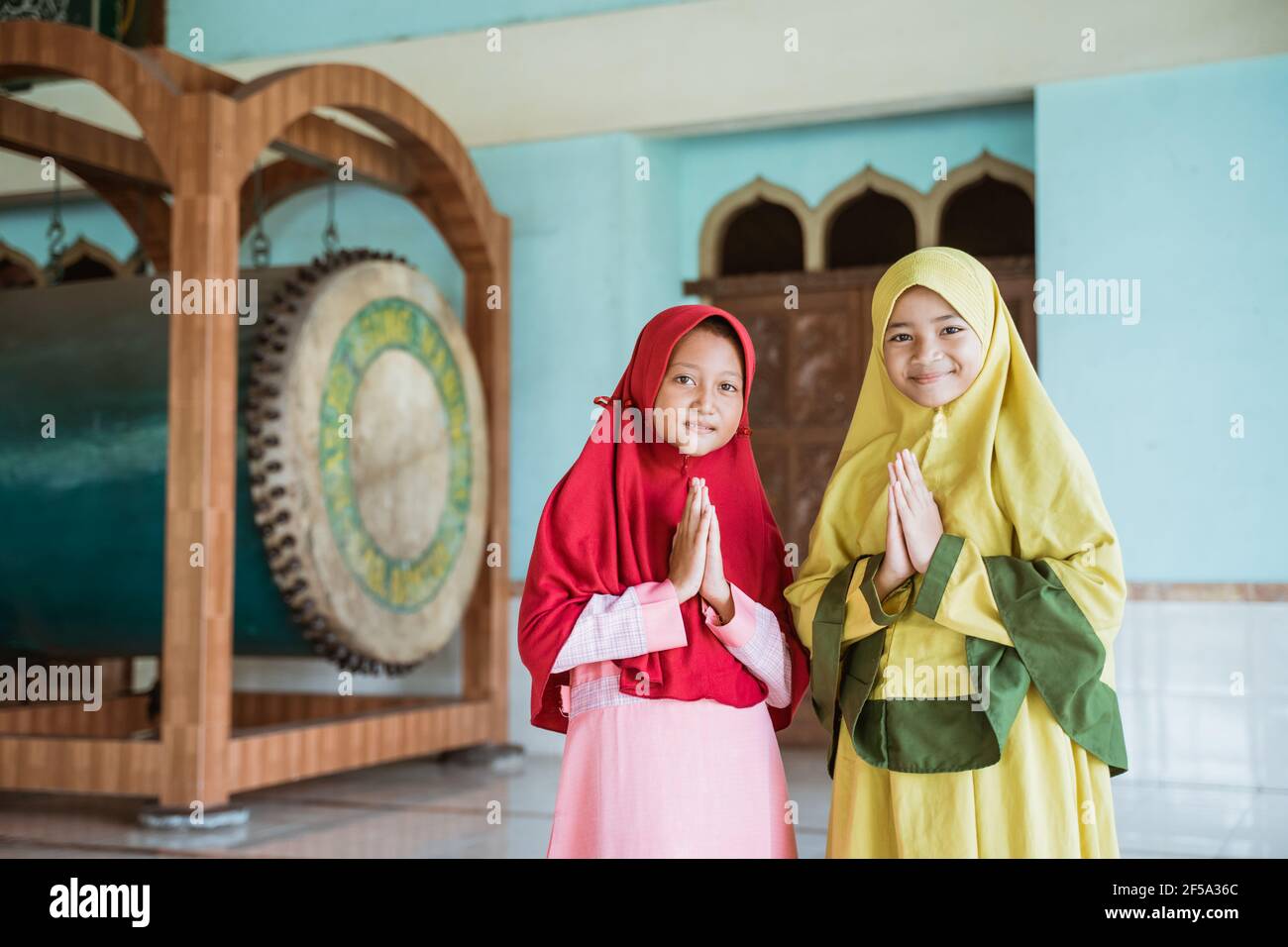 Kids girl asian Muslim pose welcome gesture hand Stock Photo - Alamy