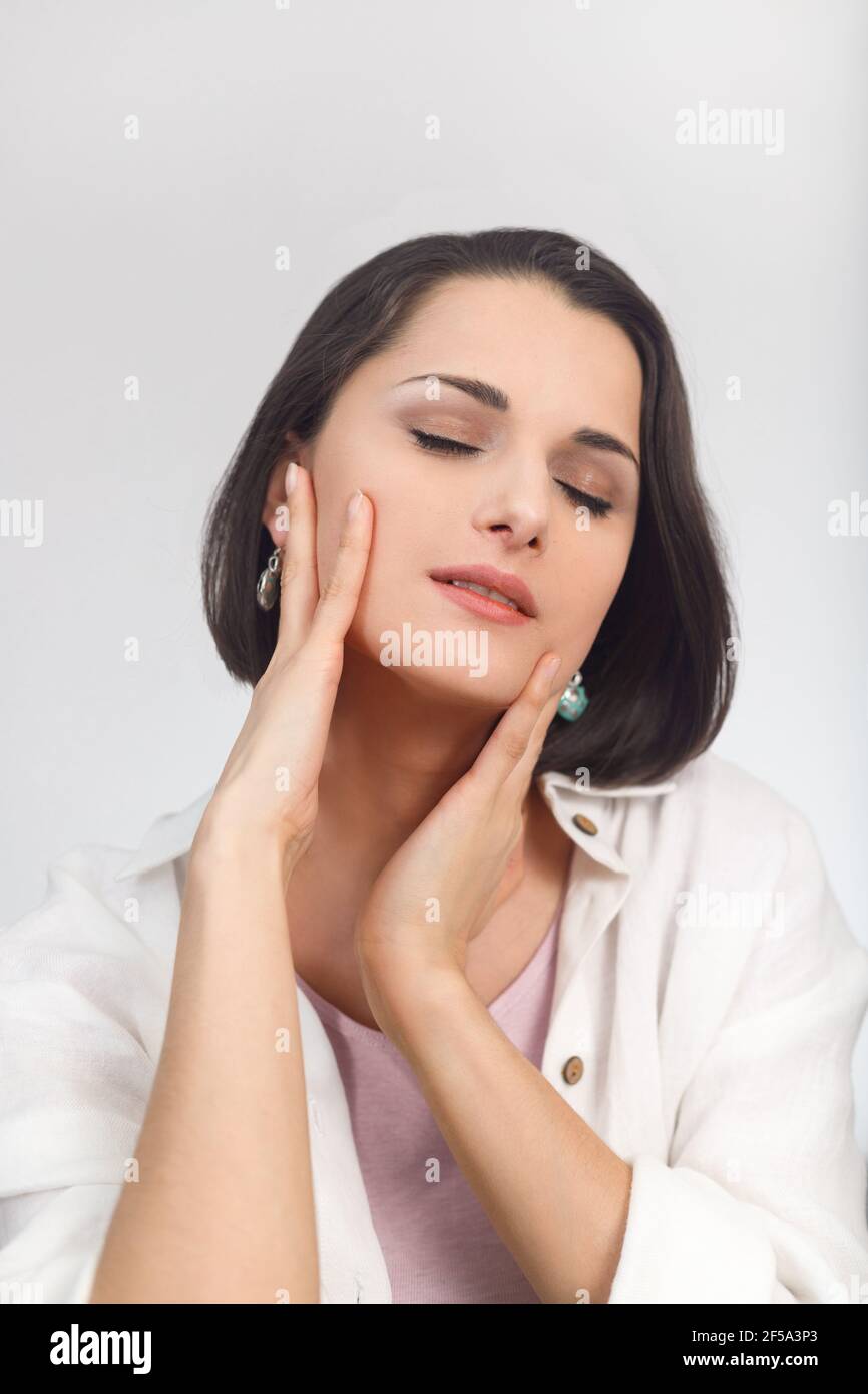 High-key headshot vertical portrait of beautiful brunette female model ...