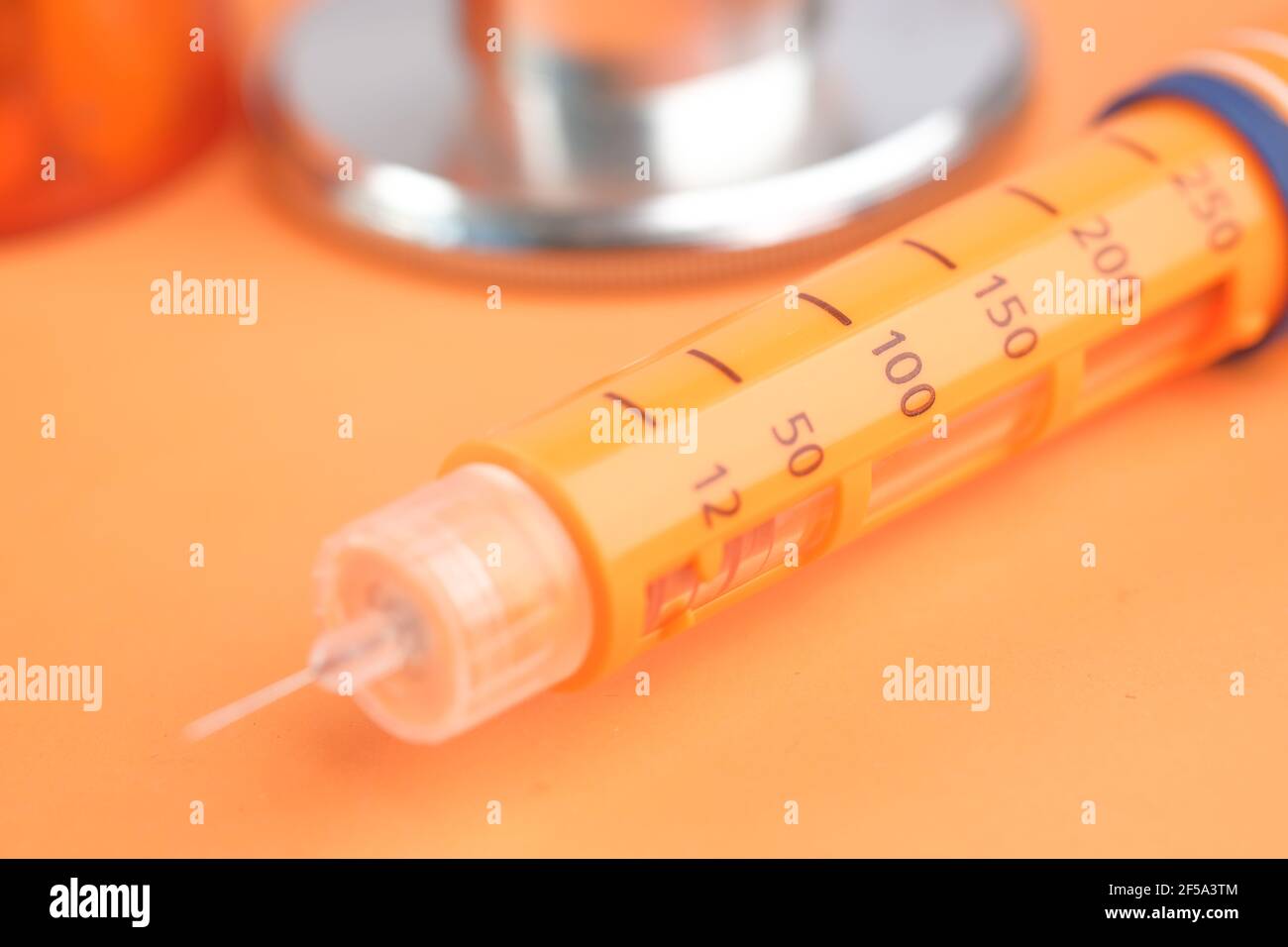 Insulin pens on orange background, close up Stock Photo - Alamy