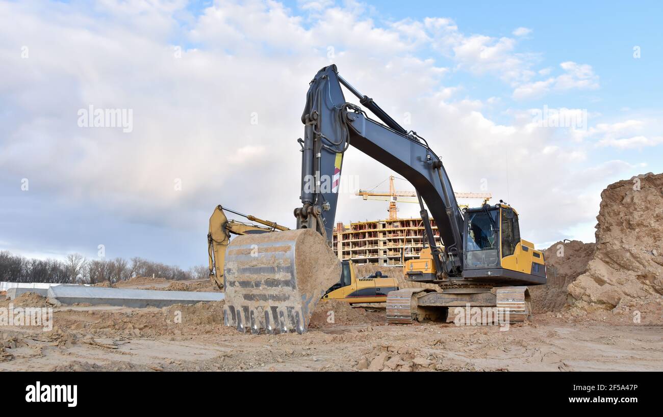 Excavator during excavation at construction site. Backhoe on foundation ...