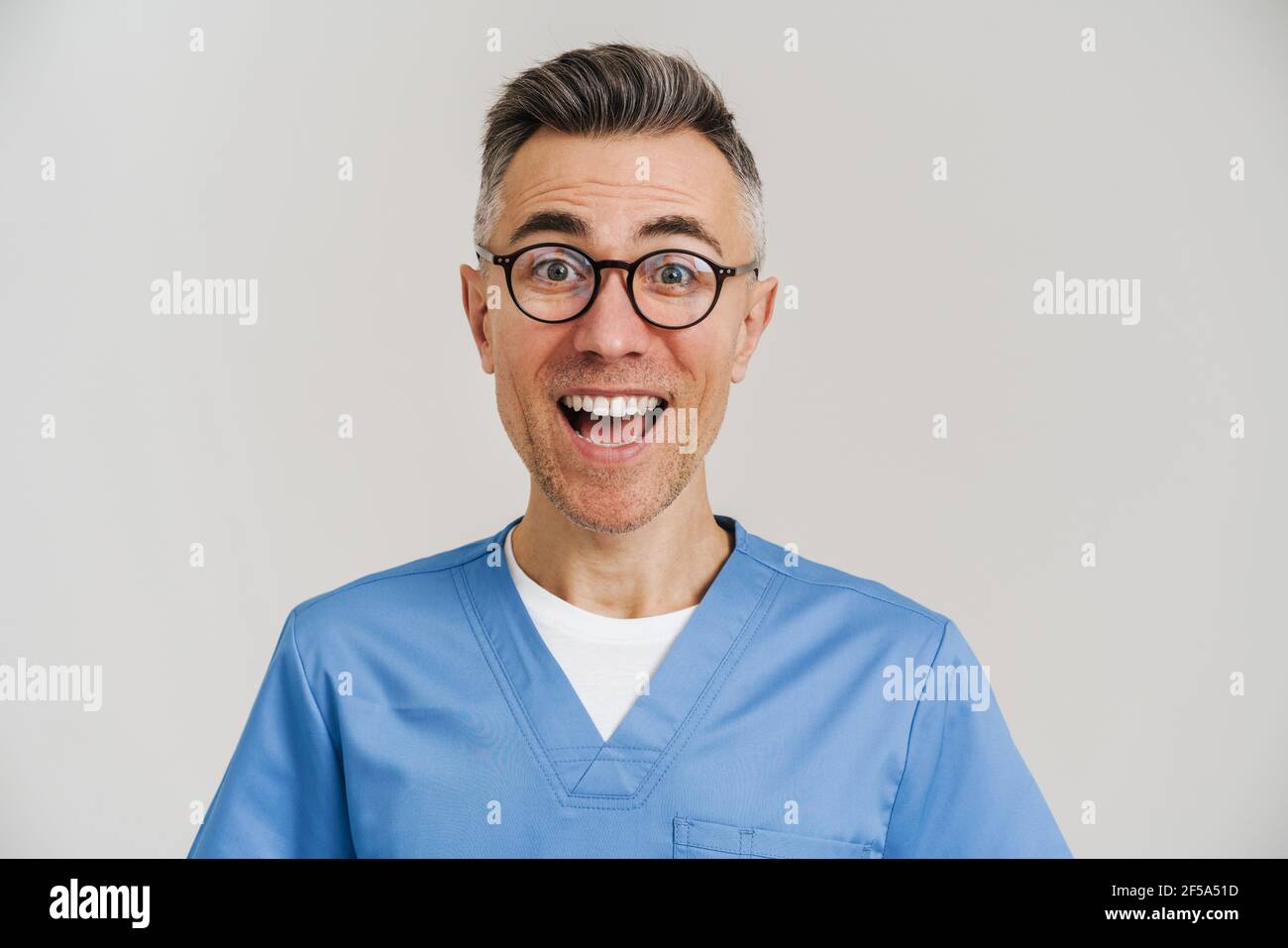 Excited white-haired medical doctor exclaiming and looking at camera ...