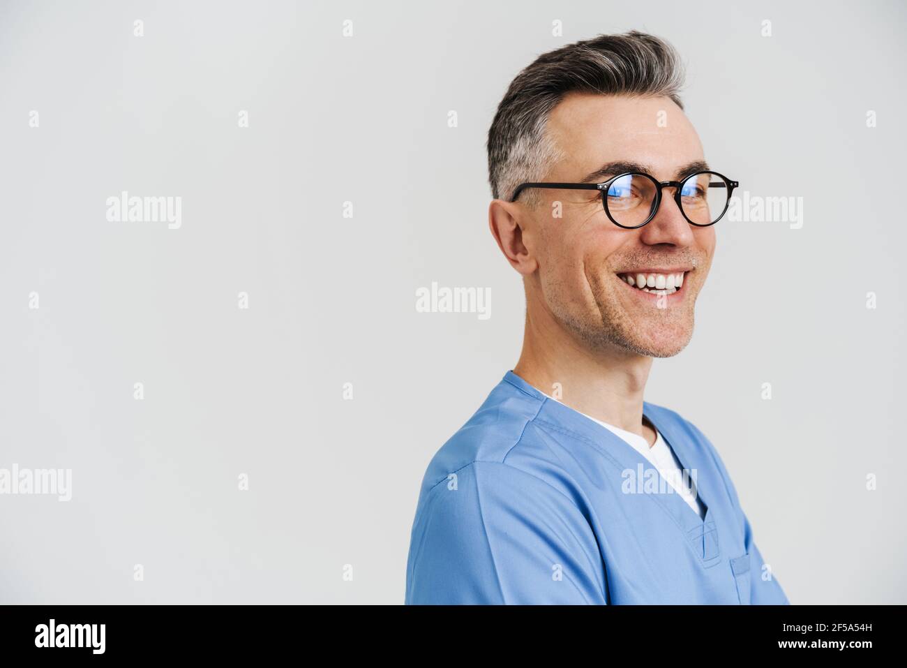 Happy white-haired medical doctor smiling at camera crossed isolated ...