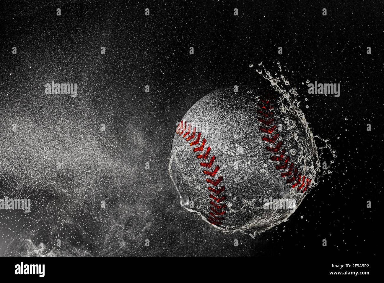 Baseball ball flying in water drops and splashes isolated on black ...