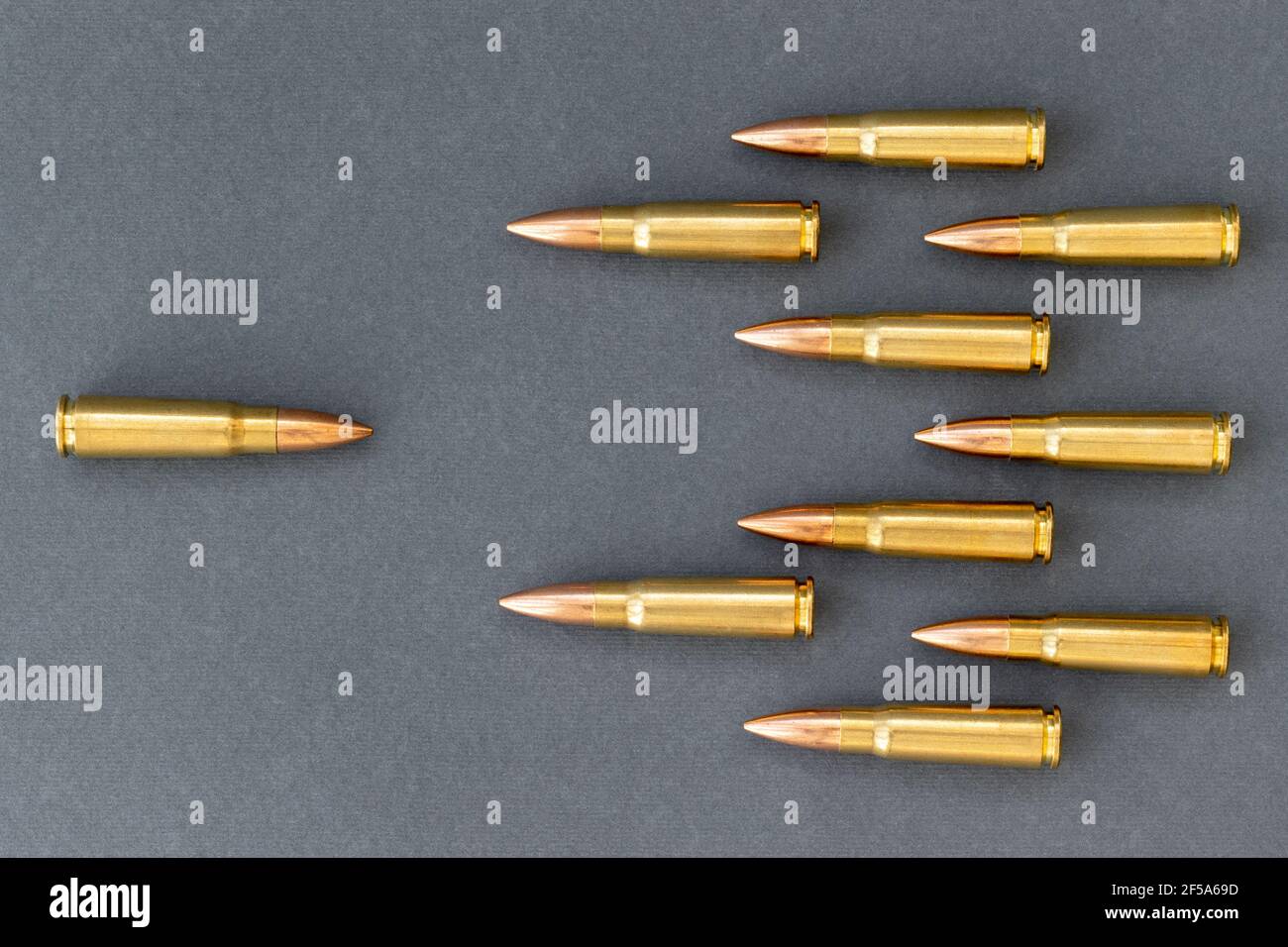 Bullets on gray paper background, one bullet in front of the others ...