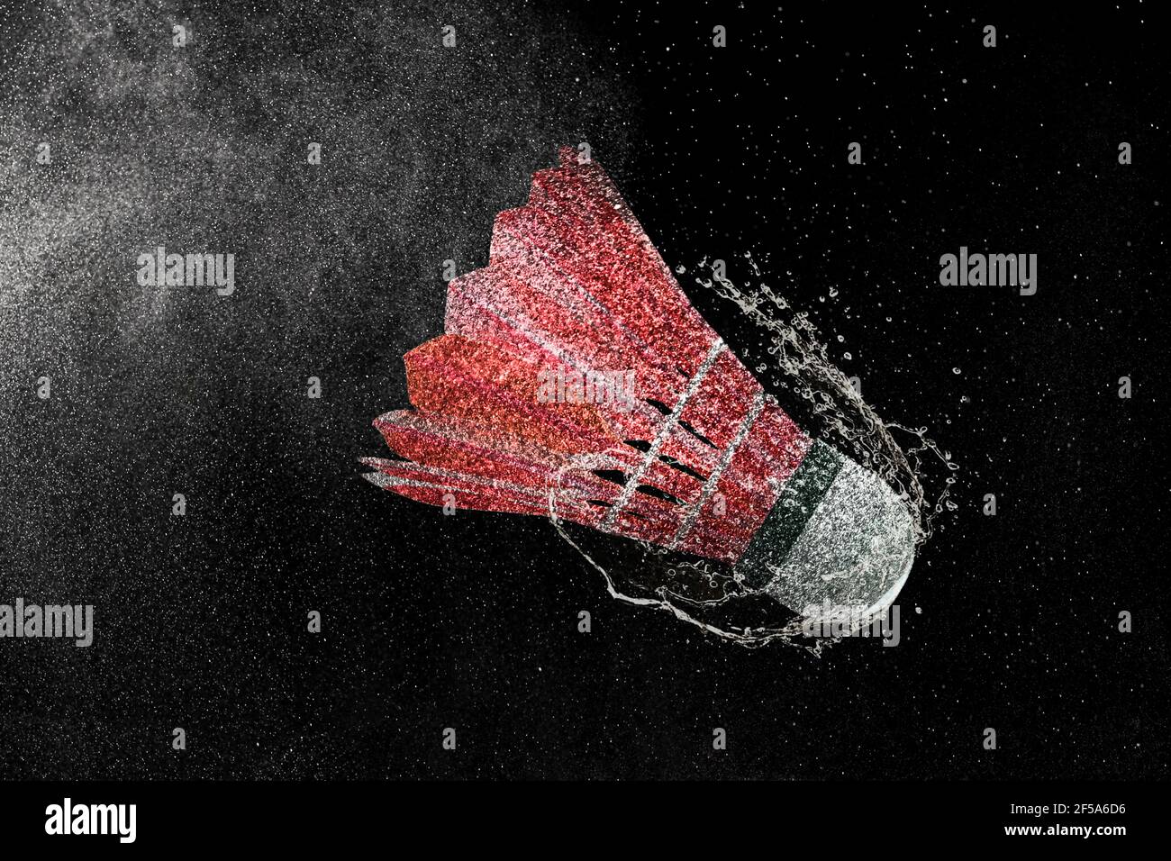 Shuttlecock in water drops and splashes isolated on black background ...