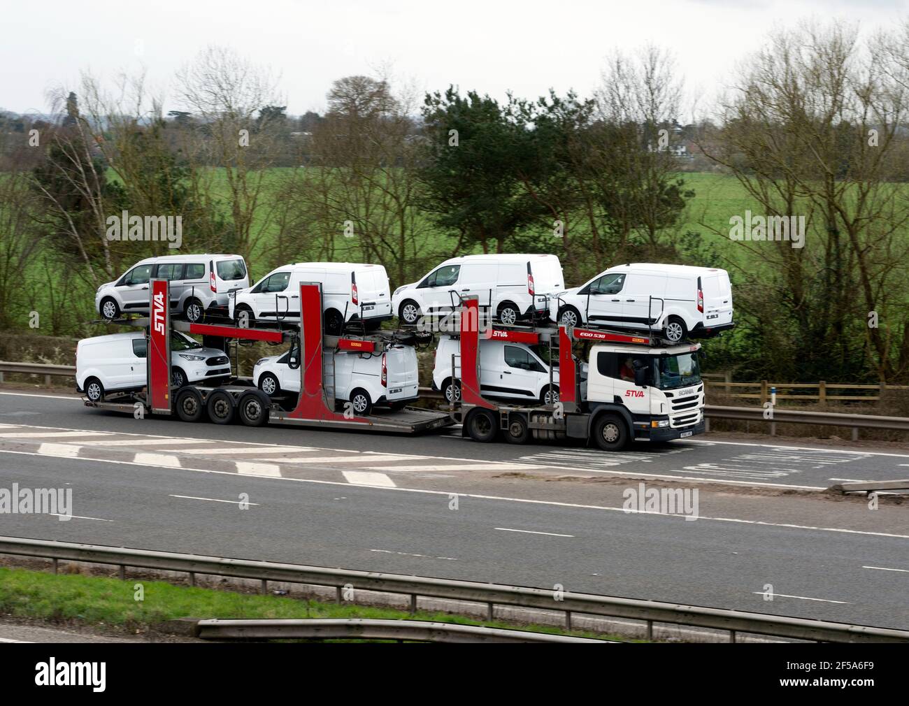 A transporter lorry carrying new Ford vehicles, leaving the M40 ...