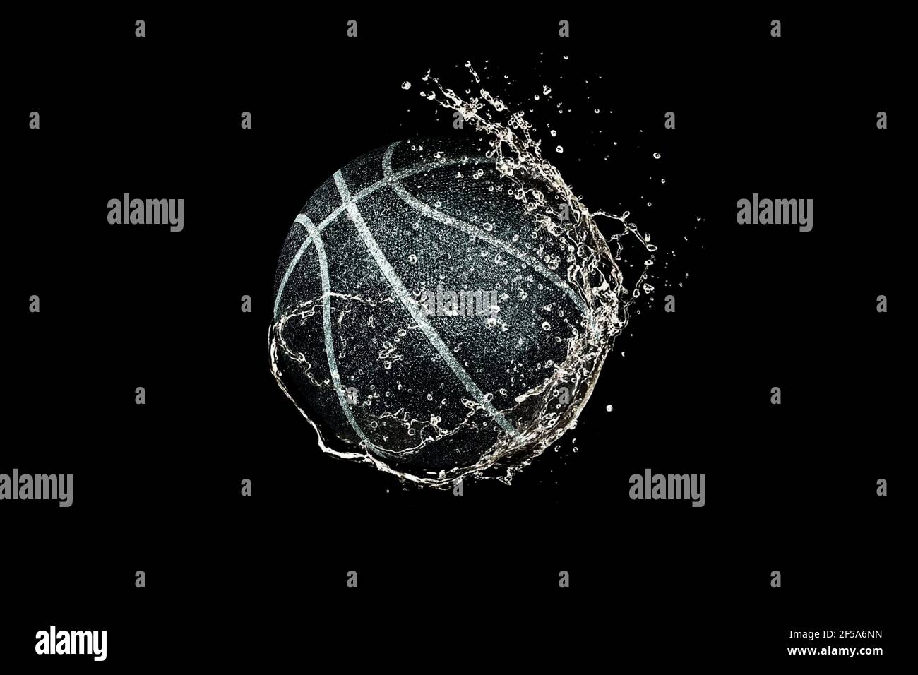 Basketball ball flying in water drops and splashes isolated on black ...