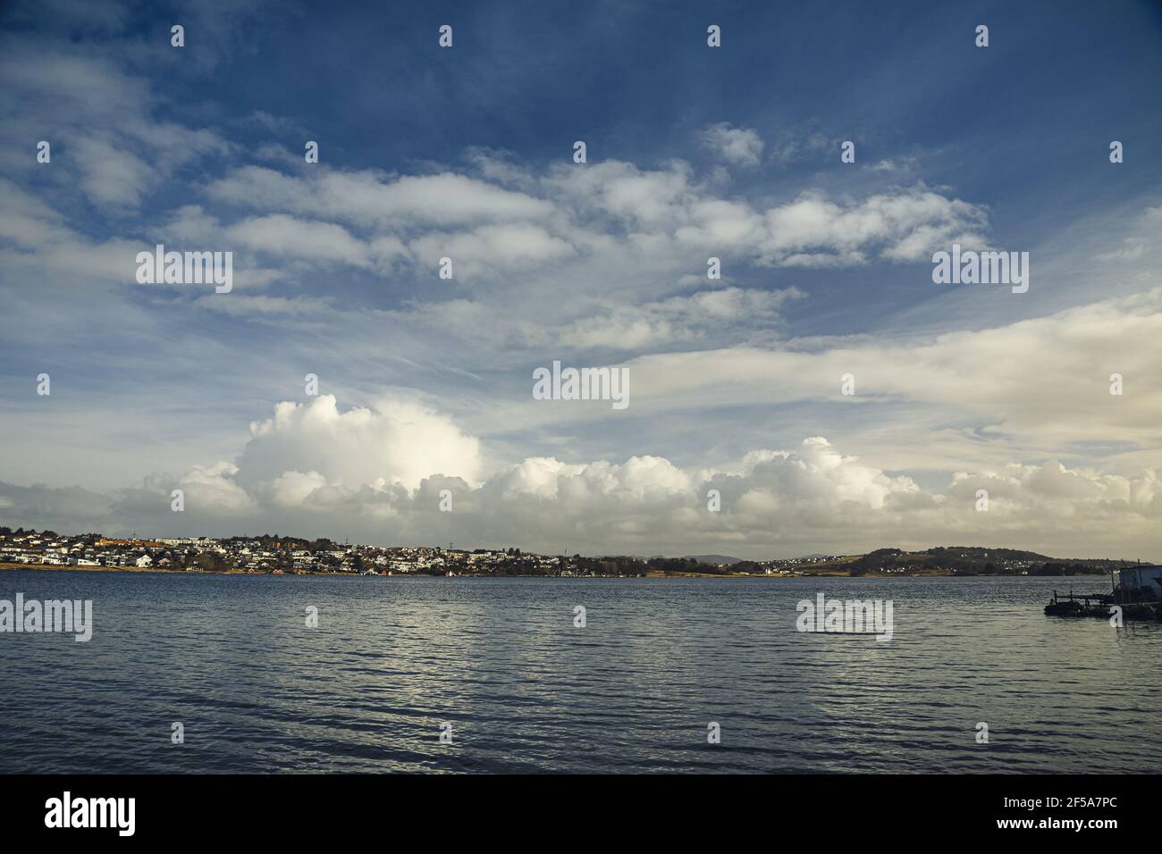 Scenic view of a calm sea under a cloudy sunset sky background Stock ...
