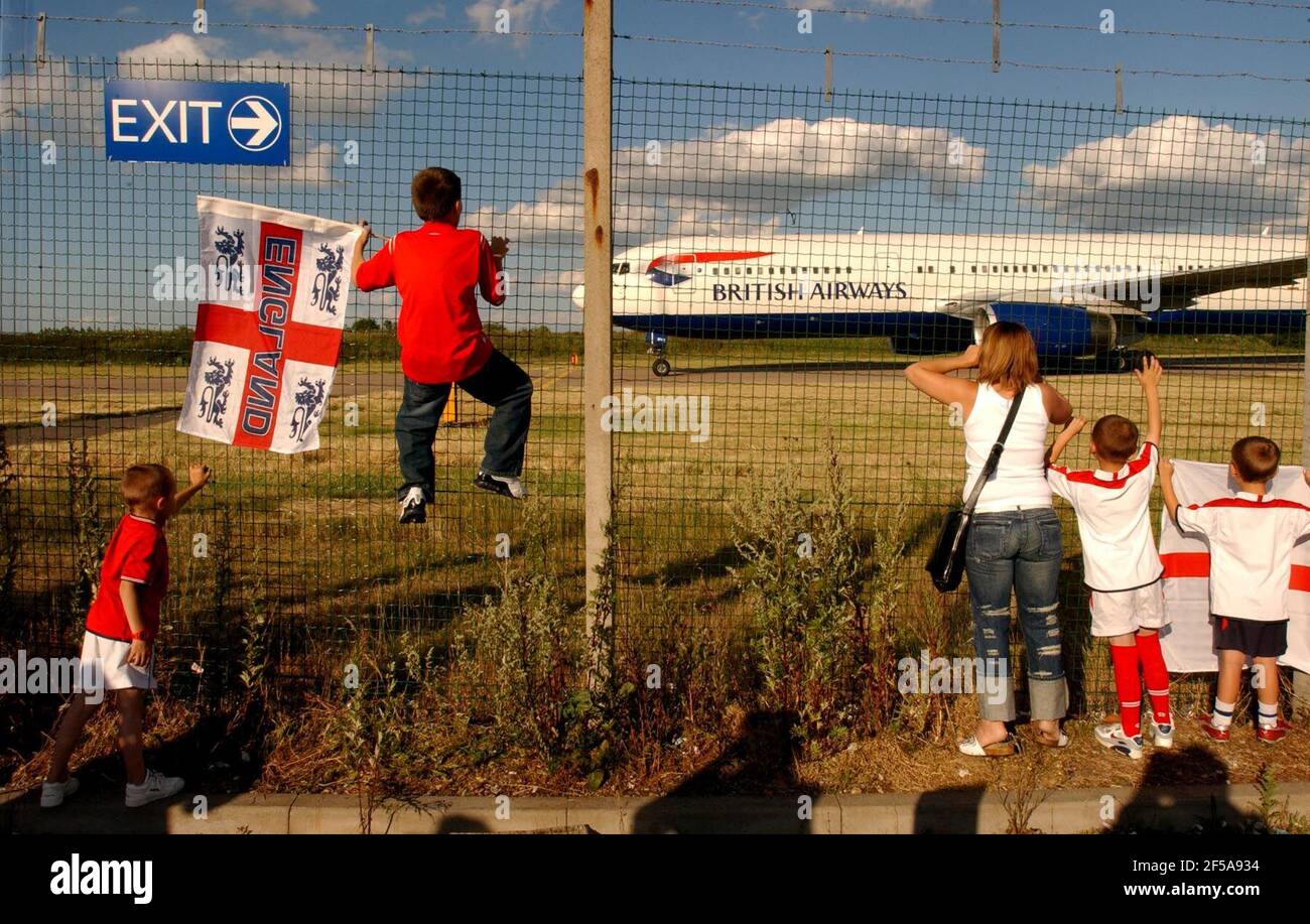 FANS WATCH THE PLANE BRINGING THE ENGLAND FOOTBALL TEAM HOME ,TAXI PAST ...