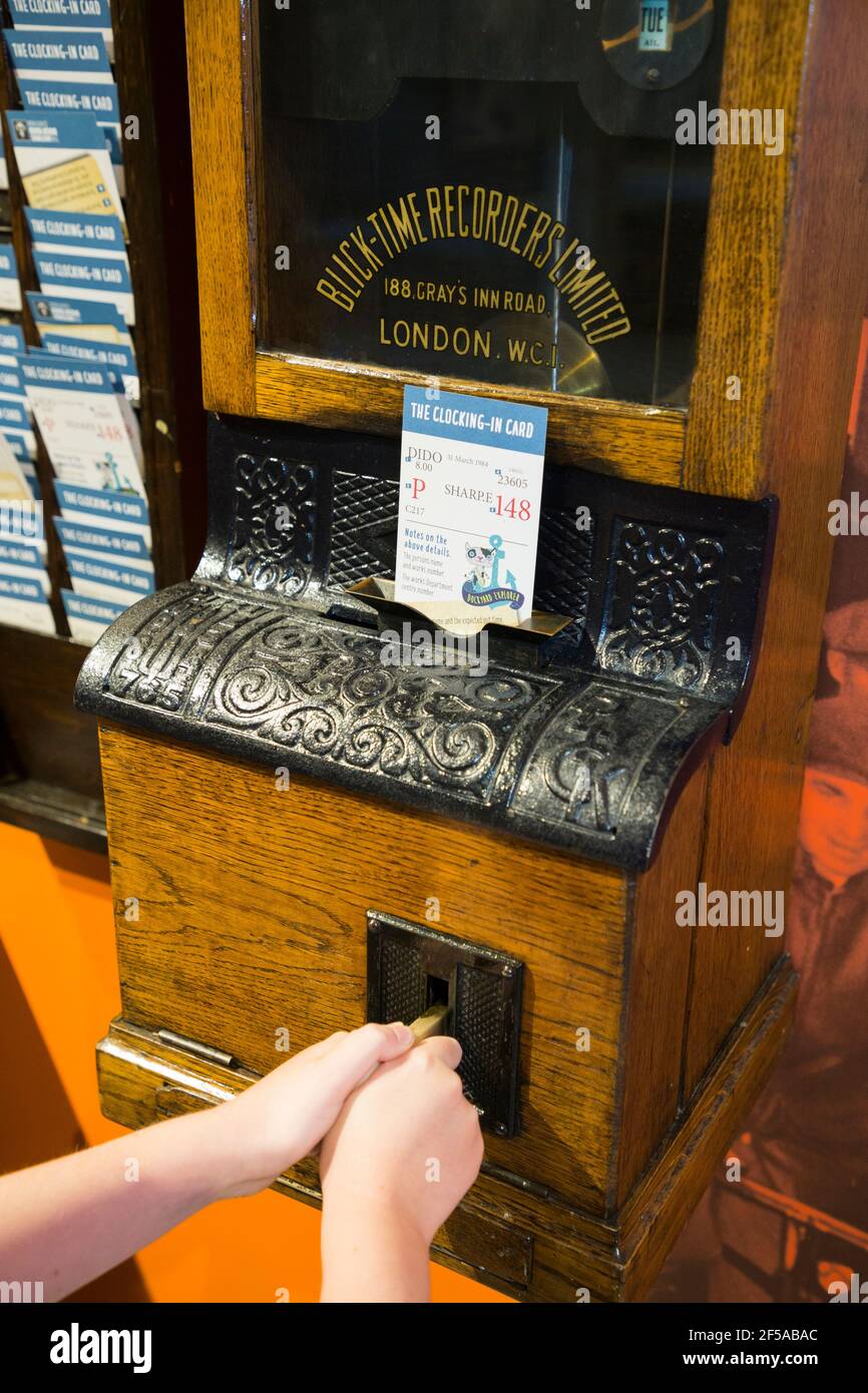 Child visitor girl tourist operating a clocking in on clock off machine ...