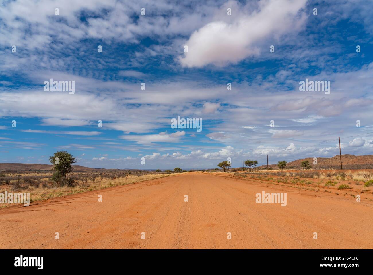 Namibian typical street with beautiful clouds and blue sky at Namib ...