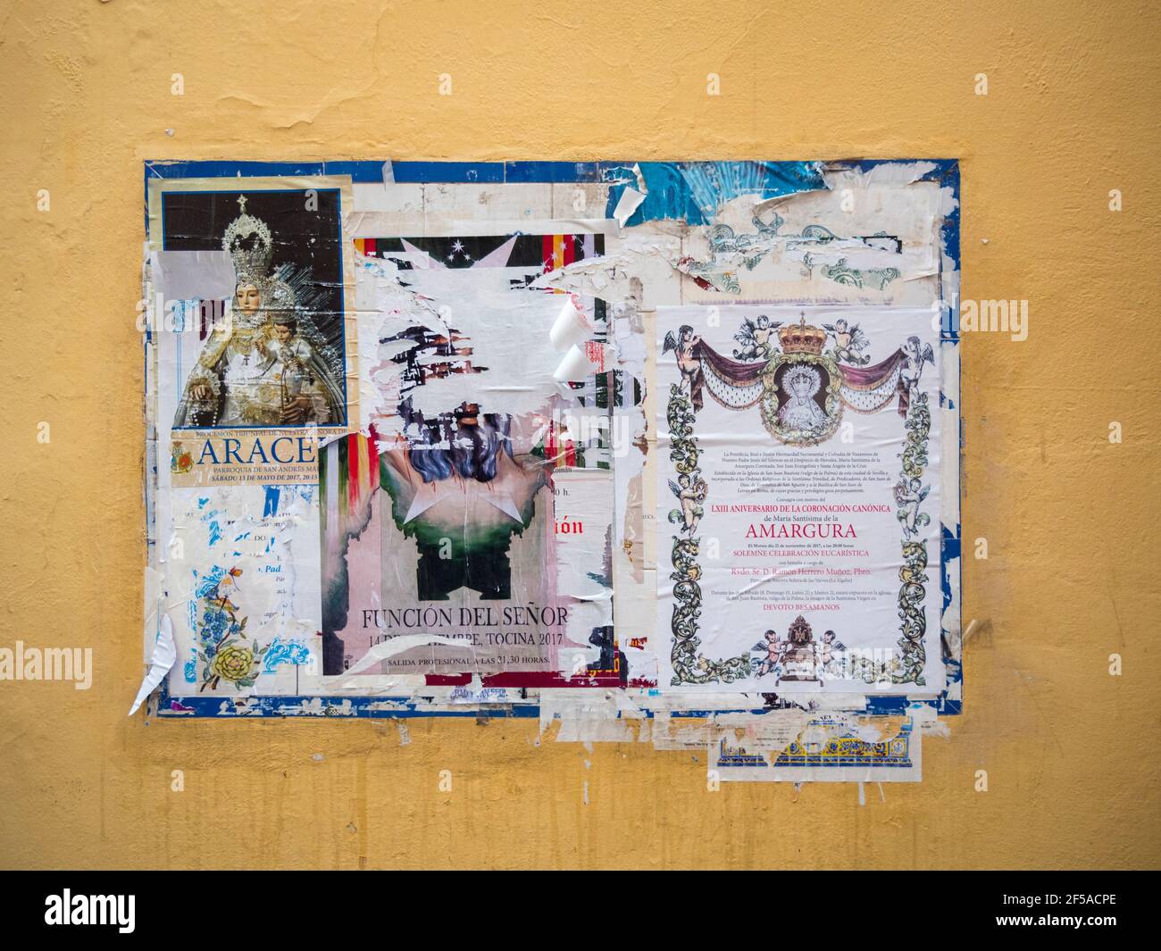 Old torn and worn posters posted on a wall in Seville Spain Stock Photo ...