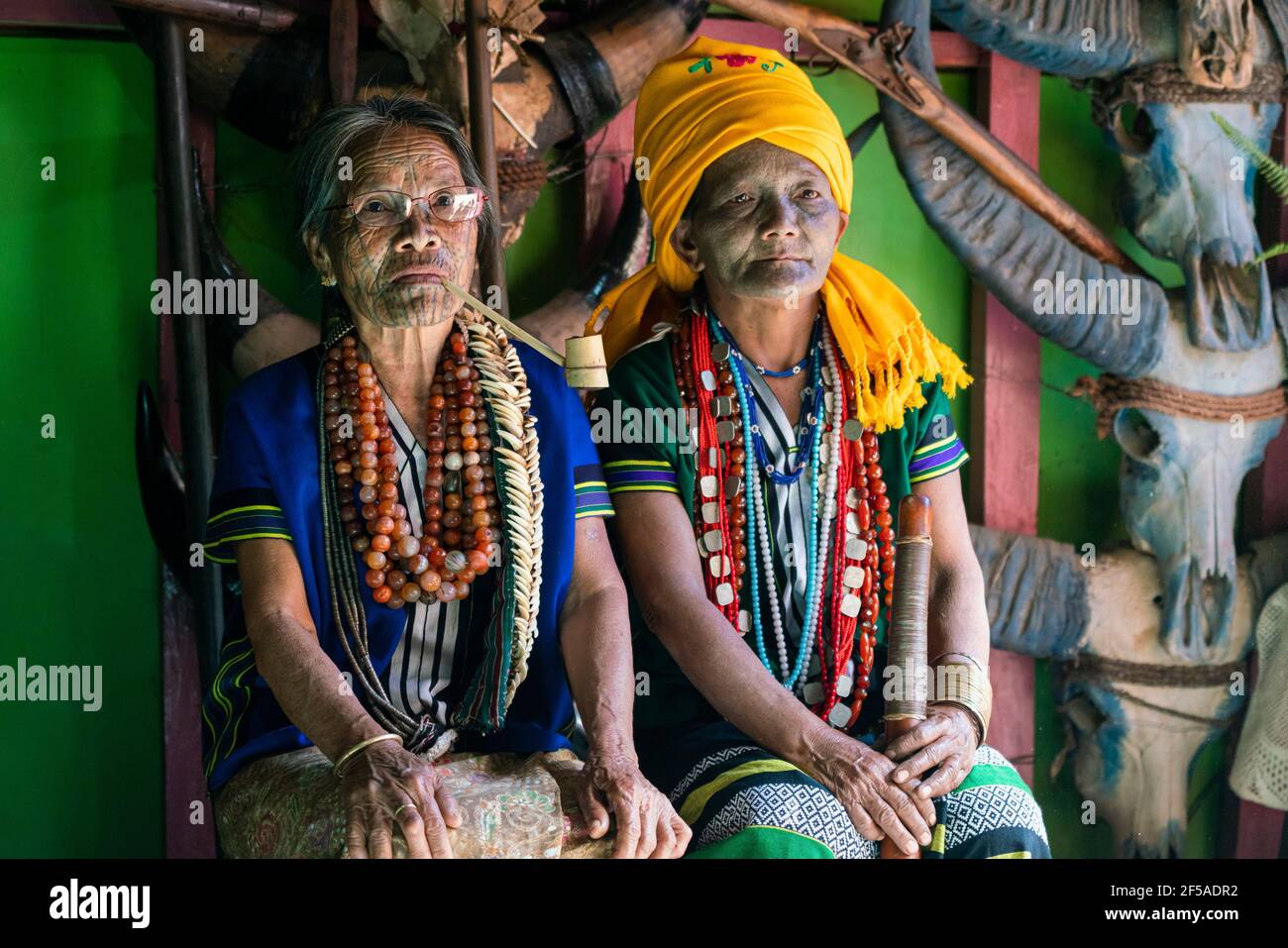 Women with tattooed faces sitting inside Mindat Museum, Myanmar Stock ...