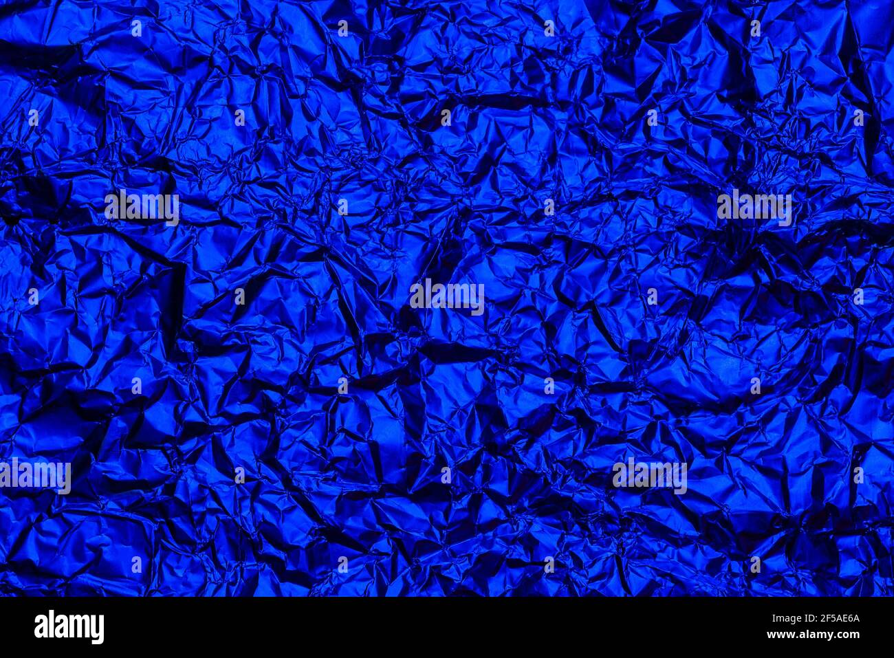 Blue foil background with shiny crumpled surface for texture background ...