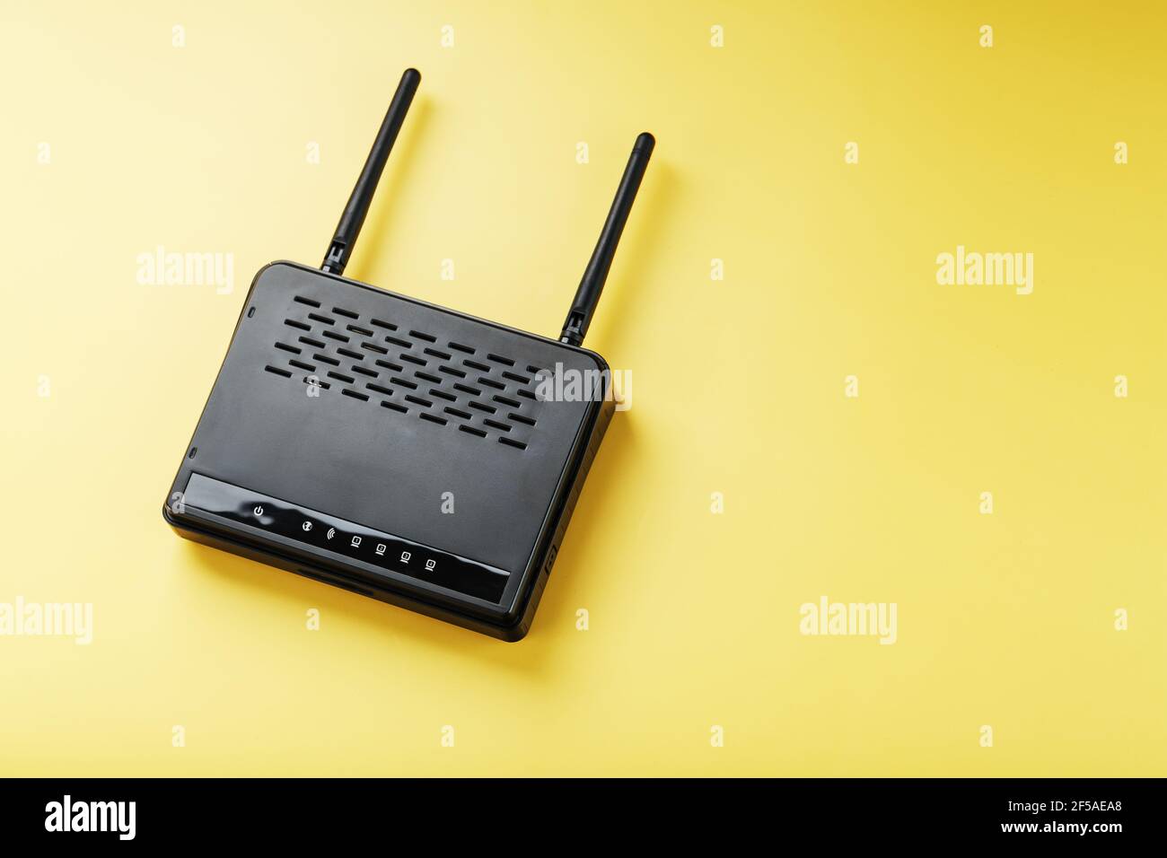 Wi-Fi router in black on a yellow background with free space. Internet ...