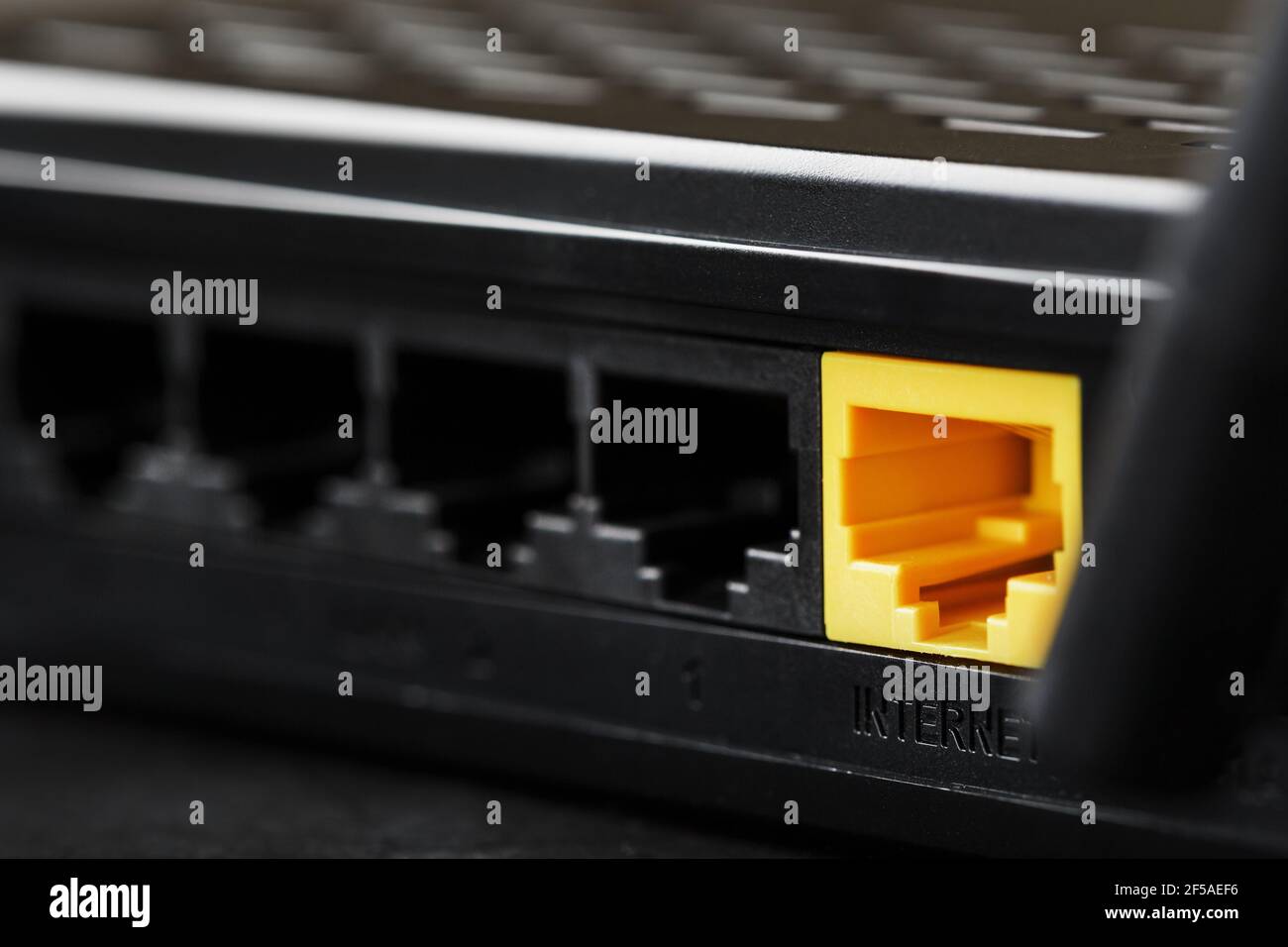 Wireless modem router with yellow cable and LAN port for connection on ...