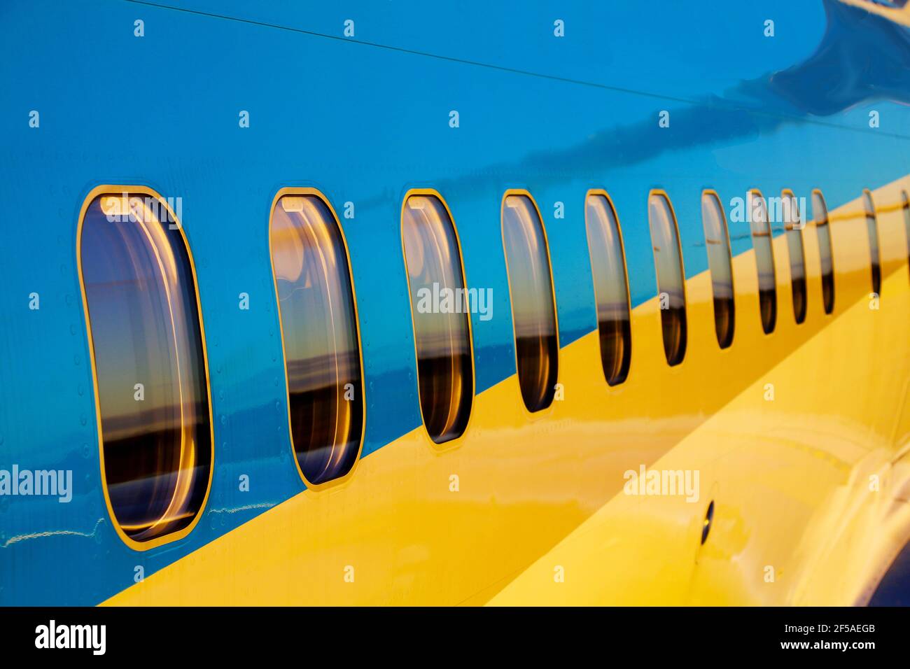 Airplane Windows on Blue Airliner Stock Photo - Alamy