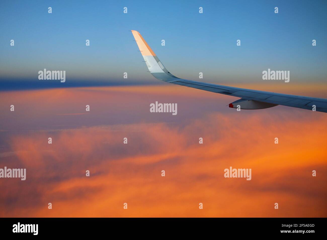 Orange Sunset Clouds from Window Seat on Plane Stock Photo - Alamy
