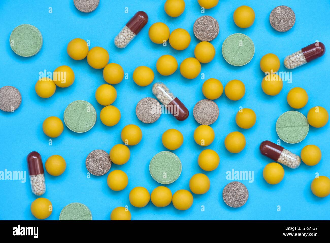 bright tablets of various shapes are scattered on a blue background ...