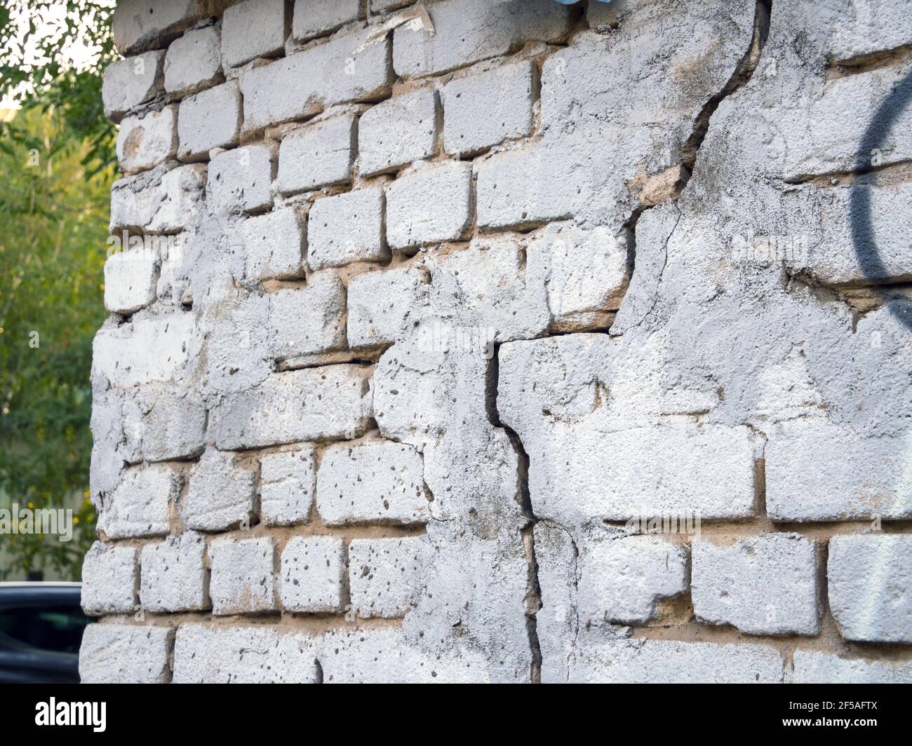 Brick wall with a crack and traces of repair Stock Photo - Alamy