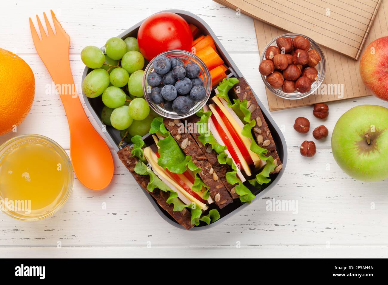 Healthy school lunch box with sandwich and fresh vegetables, water ...