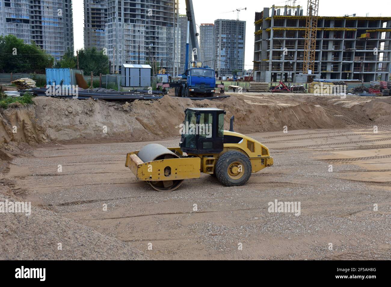 Vibro Roller Soil Compactor leveling ground at construction site ...