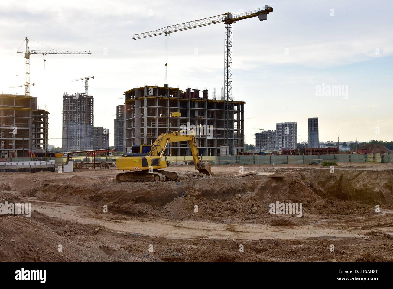 Excavator on earthmoving at construction site. Road work and Dig pit ...