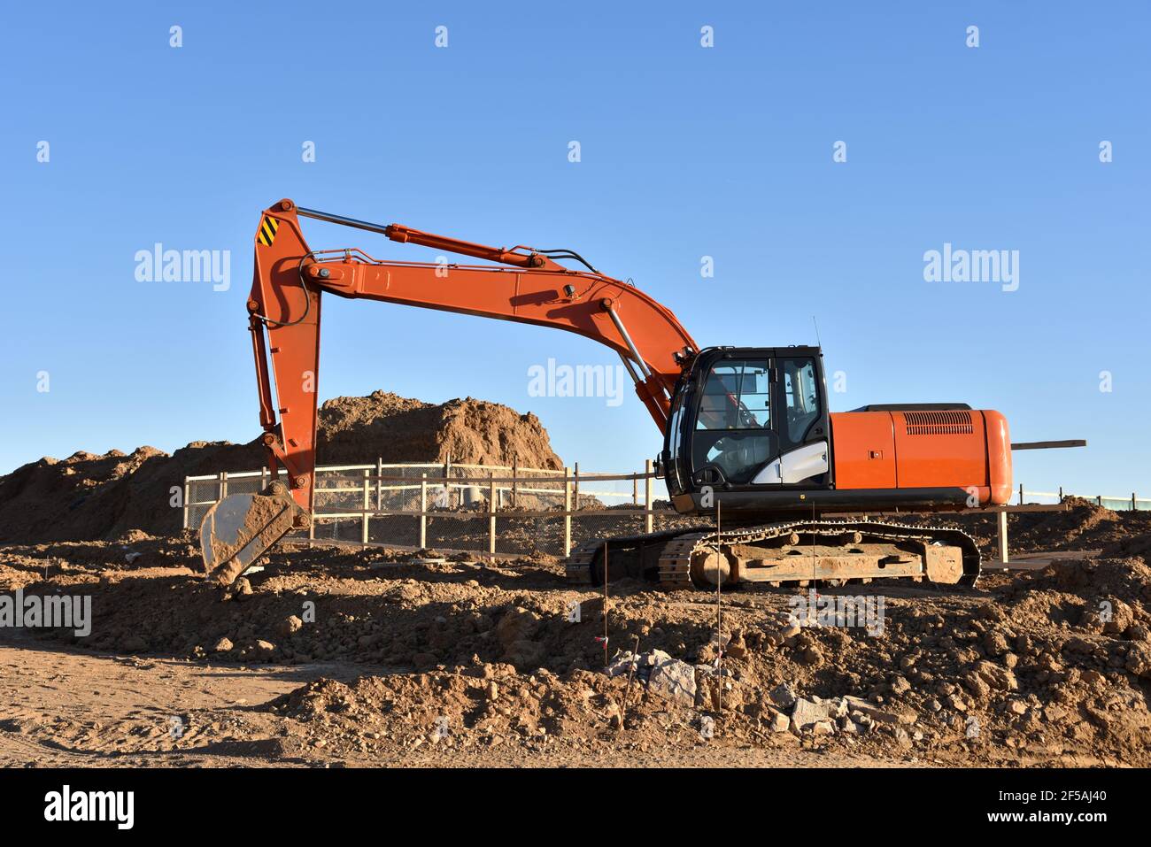 Excavator Working On Road Construction in City. Backhoe on Earthworks ...