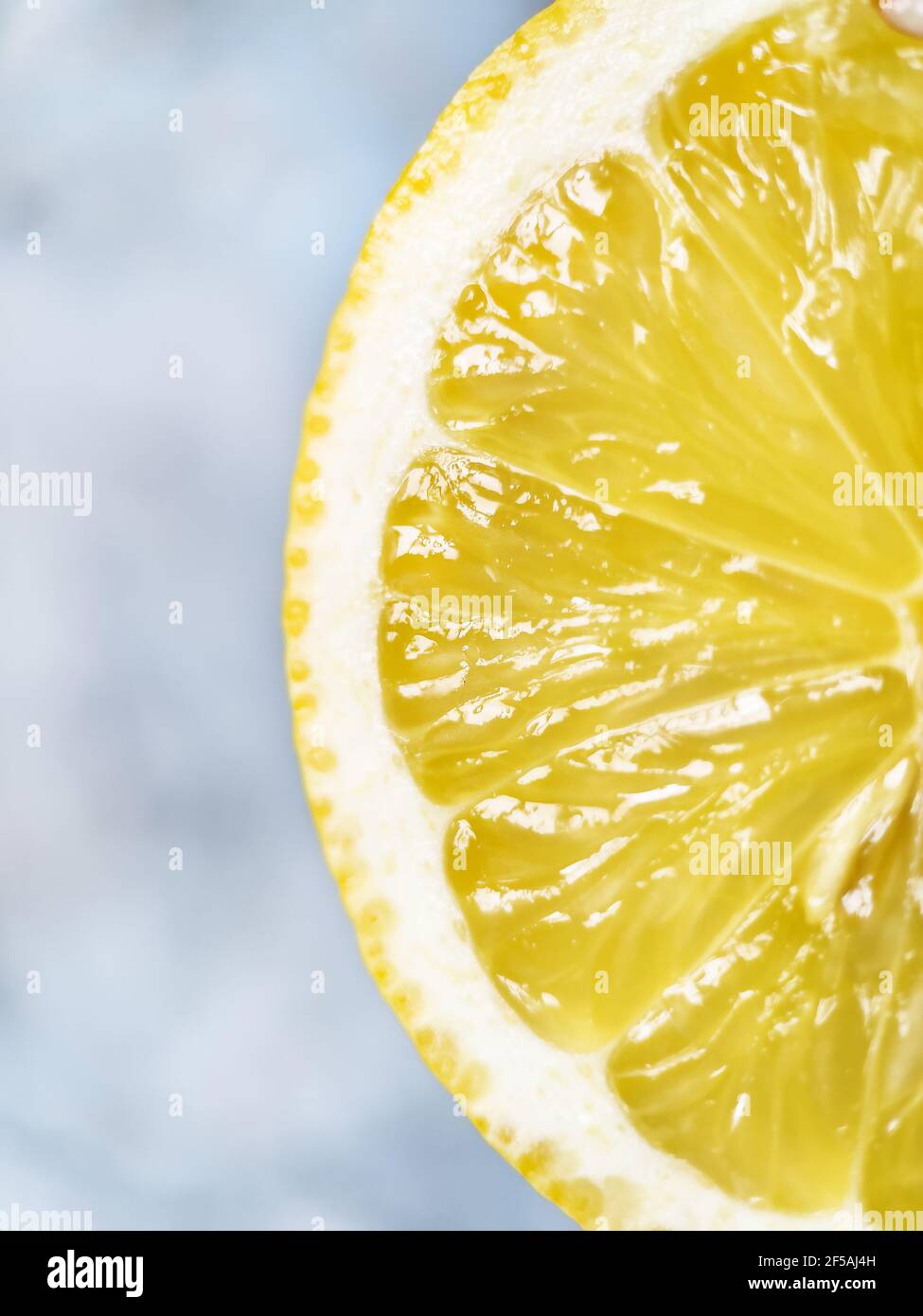 Slice of juicy fresh ripe lemon closeup. Macro photo of lemon fruit Stock Photo - Alamy